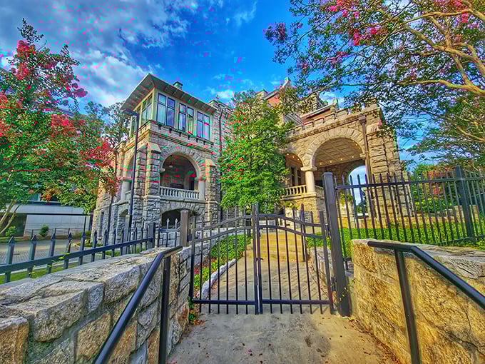 The imposing entrance gate stands like a portal to another time. Those creeping vines add just the right touch of Southern Gothic charm.