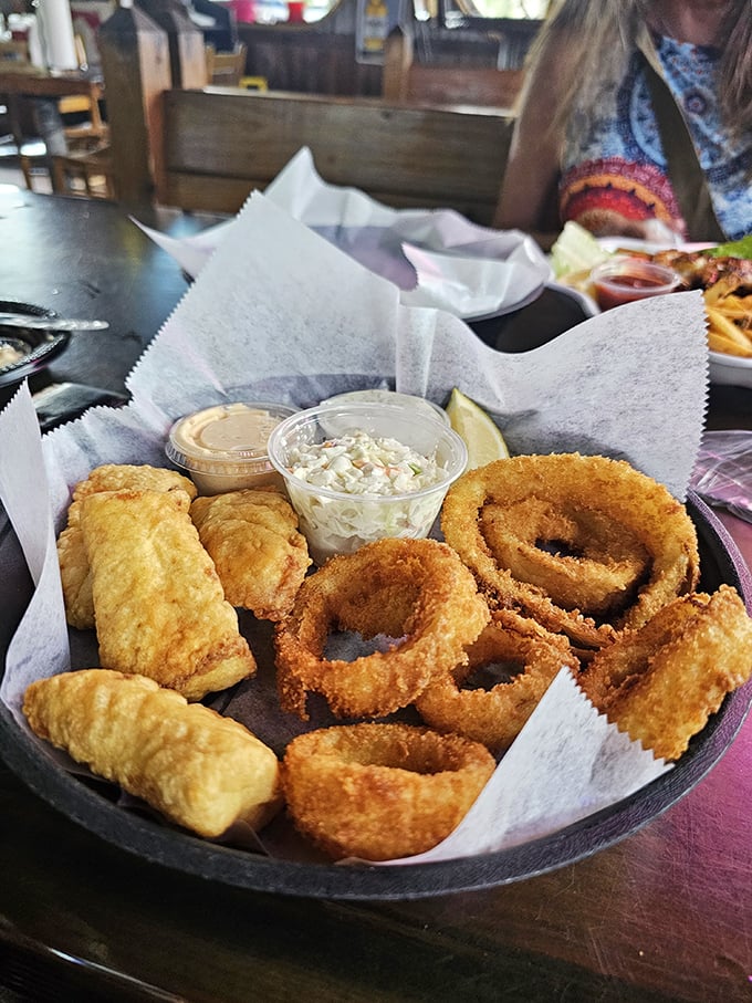 Golden-fried seafood and onion rings—proof that sometimes the simplest pleasures are the most profound. Dipping sauce not optional.
