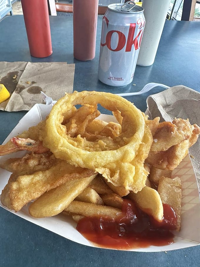 A paper boat filled with treasure more valuable than gold—perfectly fried fish and prawns that would make Neptune himself swim to shore.