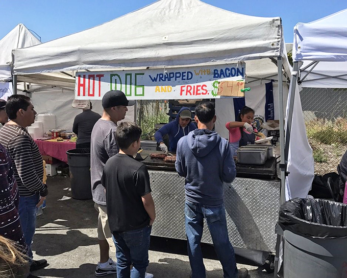 Nothing says "authentic experience" like bacon-wrapped hot dogs with fries – the unofficial fuel of flea market champions.