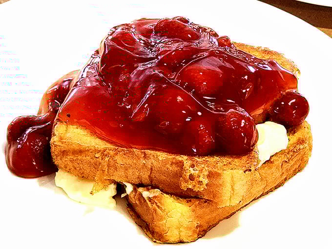 French toast drowning happily in a cherry sea. This isn't breakfast—it's dessert with a morning alibi, and we're not complaining one bit.