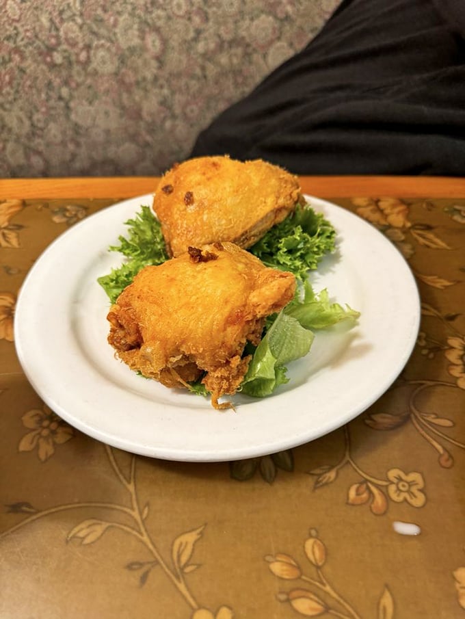 Golden-fried chicken perched on crisp lettuce – simple perfection that proves fancy plating is overrated when the cooking is this good.