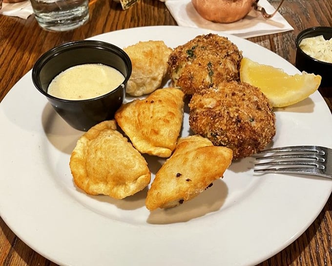 Golden-fried crab cakes with a side of dipping sauces—proof that sometimes the best things in life come in crispy, panko-crusted packages. 