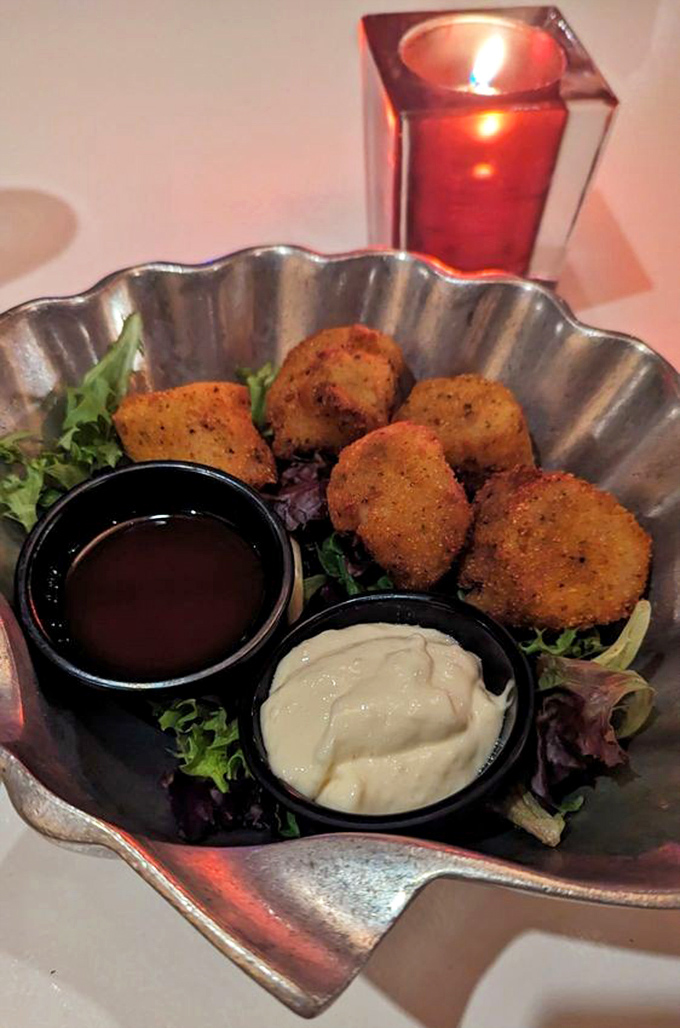 Golden-fried treasures nestled in a scalloped silver dish. These aren't just appetizers—they're little crispy preludes to the main event.
