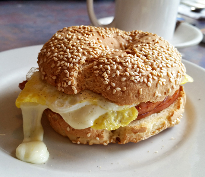 Breakfast sandwich nirvana—where melty cheese cascades over perfectly cooked egg and meat, all embraced by a toasty sesame bagel.