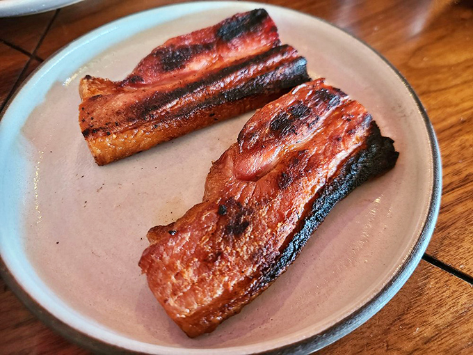 Thick-cut bacon that's been kissed by smoke and fire. Not just a breakfast side—this is bacon elevated to main character status.