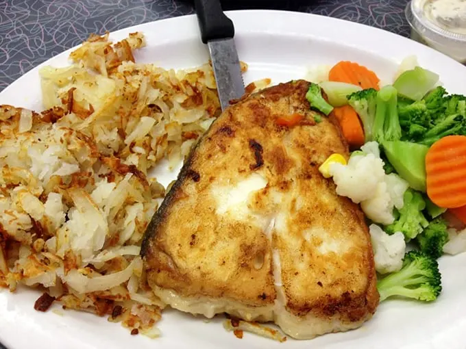 Proof that diners aren't just about breakfast—this perfectly grilled fish with colorful vegetables shows Uncle Bill's range extends well beyond eggs.