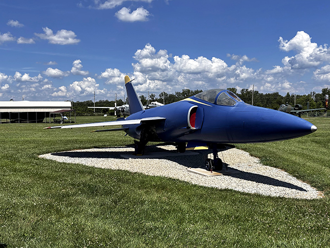 The navy-blue F-11 Tiger gleams in the Indiana sunshine, its aerodynamic profile a testament to the golden age of jet fighter design. 