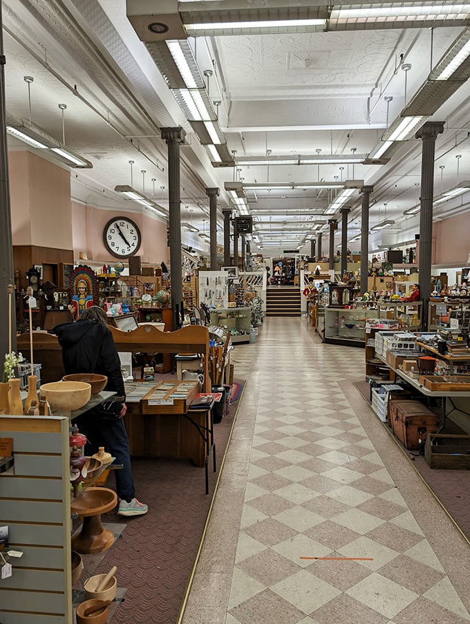 The expansive main floor stretches toward possibility, with treasures organized into browsable sections. That checkerboard floor practically begs for a giant chess match.