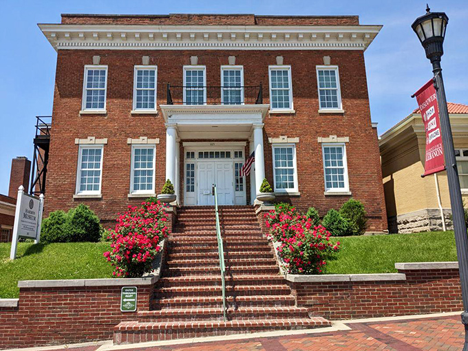 The Harmon Museum welcomes visitors with brick steps and blooming azaleas—history that doesn't mind dressing up for company.