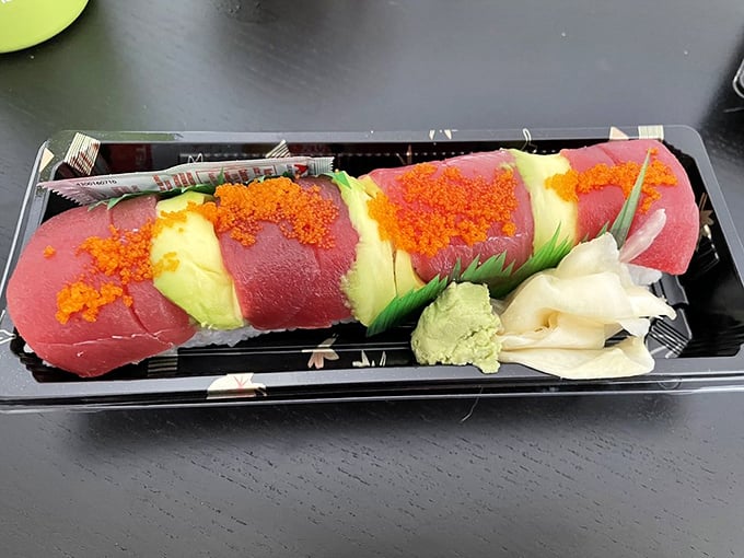 A Hawaiian roll that's dressed to impress – alternating slices of tuna and avocado topped with vibrant tobiko, like a tropical vacation for your taste buds.
