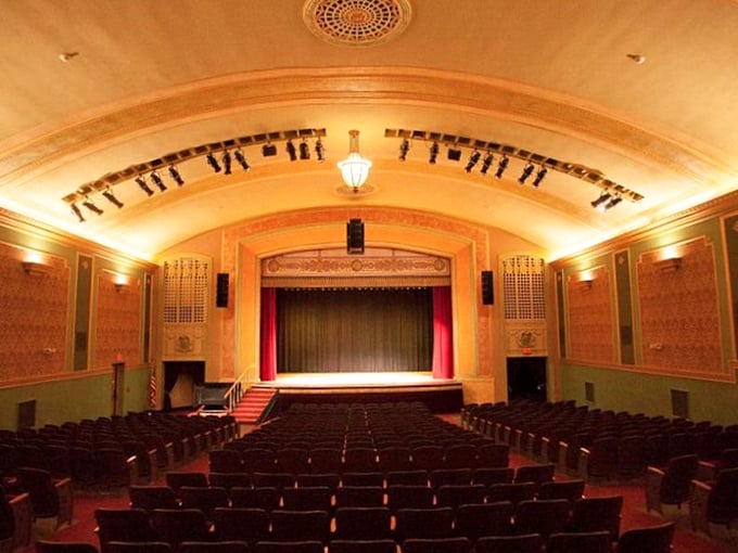 The Temple Theatre's golden glow and curved ceiling transport you to a time when movies were events and popcorn didn't require a second mortgage.