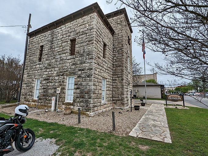 The old Hood County Jail now holds stories instead of prisoners—its limestone walls have witnessed more drama than a season of Yellowstone.