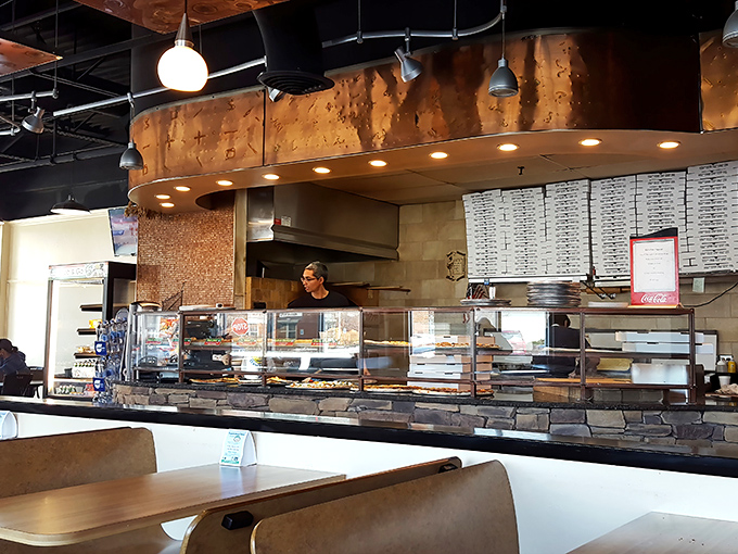 The open kitchen concept isn't just trendy—it's a stage where pizza-making becomes performance art worth the price of admission.