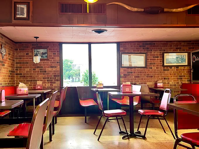 Brick walls, ceiling fans, and those red chairs—the dining room feels like it's been waiting for you to discover it since forever ago.