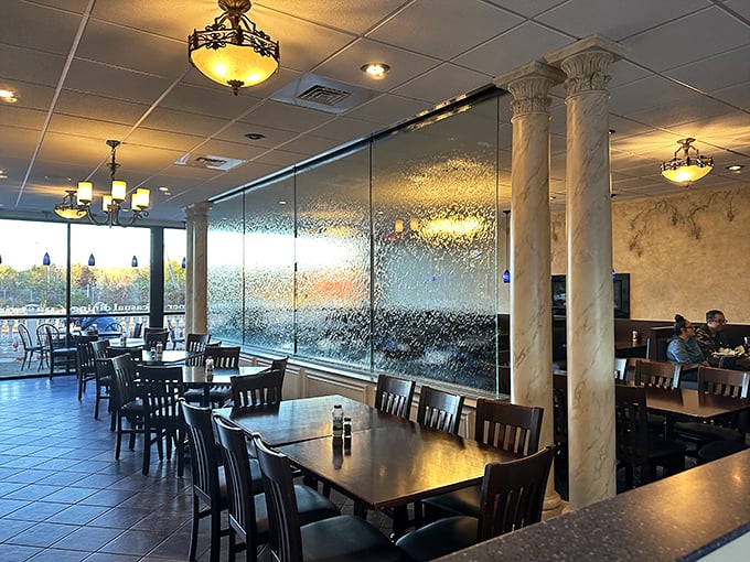Sunlight streams through textured glass, creating a dining room that feels both intimate and open. Those columns aren't just decorative—they're transporting.