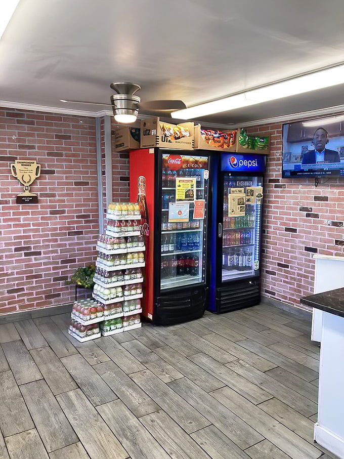 The beverage corner – where cold drinks await their sandwich soulmates. Brick walls and wood floors create the perfect stage for culinary magic.