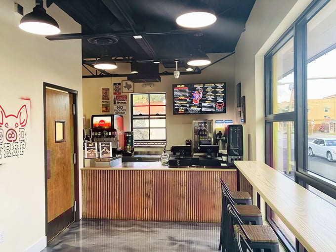 Clean lines and butcher diagrams create an atmosphere where serious barbecue meets modern dining comfort.