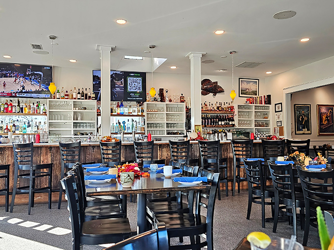 The dining room balances coastal casual with culinary serious—where blue plates promise ocean treasures and conversations flow like wine.