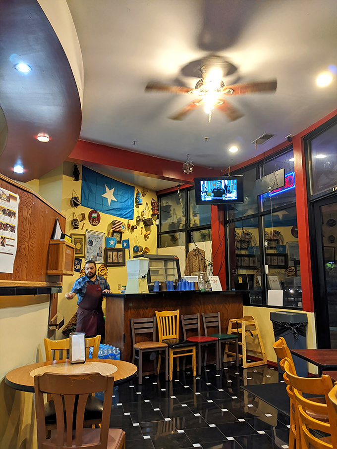 The Somali flag and cultural artifacts transform a simple dining room into a genuine experience—dinner and a geography lesson in one.