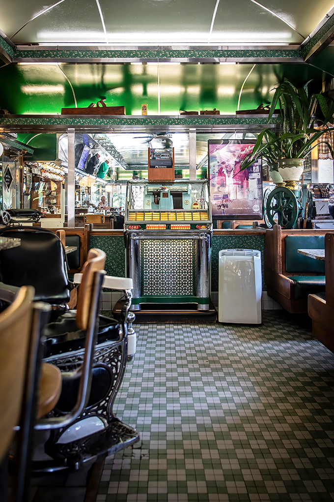 The diner's interior glows with that distinctive green charm—like being inside a perfectly preserved time capsule where calories don't count.