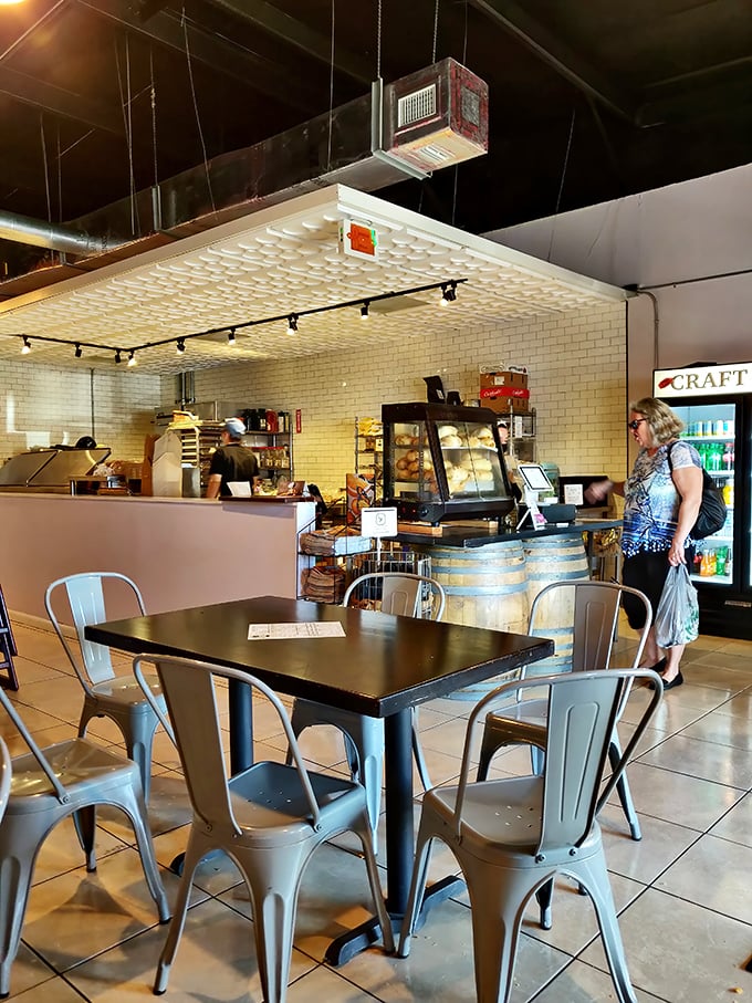 The counter setup feels like bread theater, where wine barrels meet industrial chic and every surface tells you something delicious is happening here.