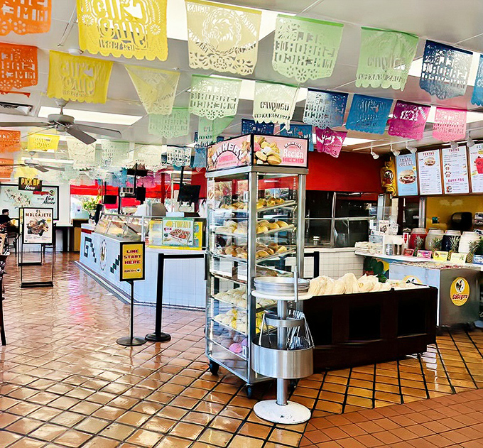 The papel picado ceiling and well-stocked bakery cases aren't just decoration – they're a promise that what you're about to eat comes from generations of tradition.