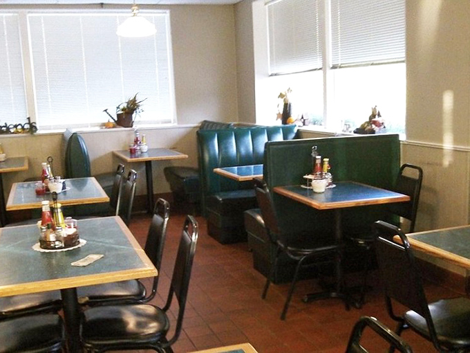 Another dining area showcases teal booths against cream walls—unpretentious and ready for the serious business of enjoying good food.