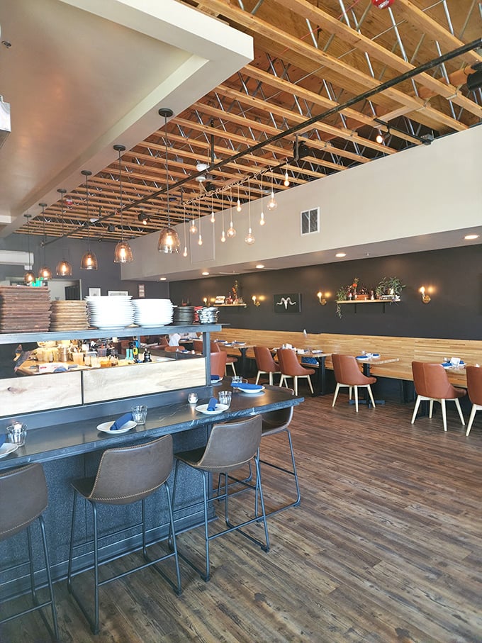 Exposed wooden beams, pendant lighting, and thoughtful design create an atmosphere where comfort meets sophistication. Dinner and a show—architectural edition.