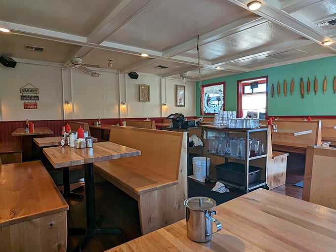 Wooden booths that have heard more mountain stories than a park ranger. The turquoise accent wall adds just enough hipness without trying too hard.