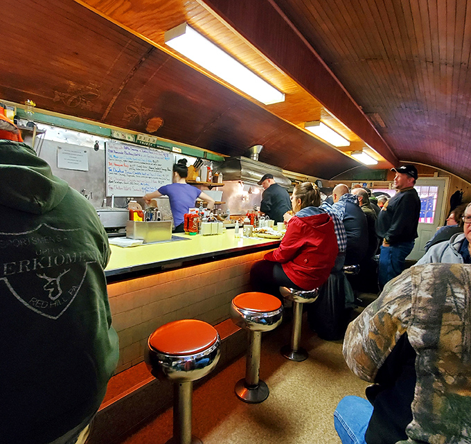 The breakfast rush creates a symphony of sizzles while locals gather for their morning ritual.