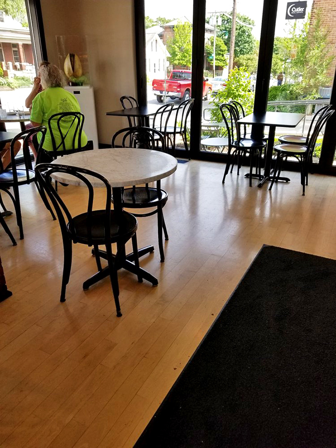 The café's interior offers a front-row seat to pastry theater, where light wood floors and bistro chairs create the perfect backdrop for your sugar-induced euphoria.