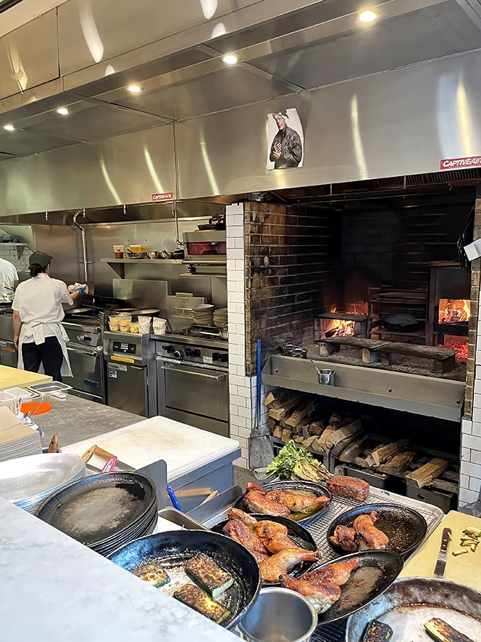 That wood-fired hearth isn't just equipment—it's the restaurant's beating heart. Watch as flames lick the edges of whatever's about to become your dinner.