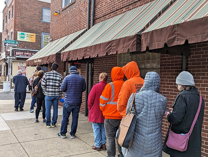 Saturday morning pilgrims waiting for their weekly dose of happiness wrapped in white paper.