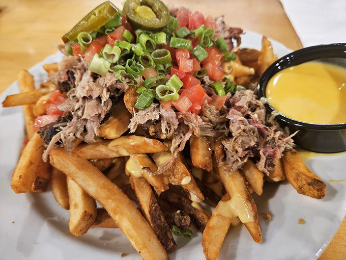 These aren't just fries—they're a foundation for pulled pork, jalapeños, and cheese sauce in a dish that demands both hands and napkins.