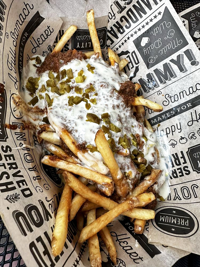 These loaded fries aren't just a side—they're a main event draped in melty cheese and green chile, demanding your full attention.