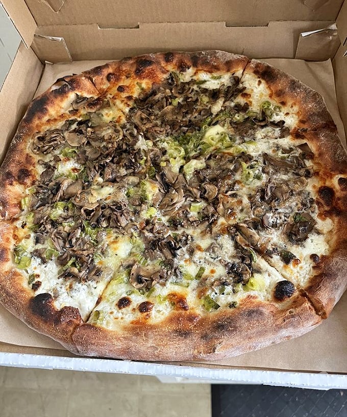 The mushroom pizza isn't just a topping choice—it's a fungi festival where earthy mushrooms and melty cheese perform a perfect culinary tango.