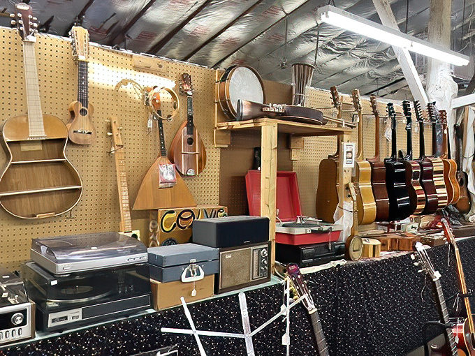 A musician's treasure trove where vintage guitars and record players await their second act in someone's living room jam session.
