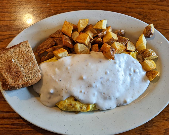 Breakfast nirvana: a country skillet smothered in creamy gravy with eggs on top—the kind of dish that makes you want to hug the cook.