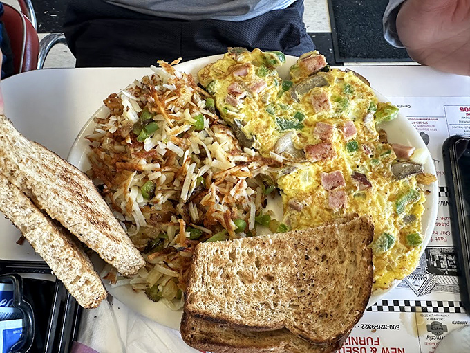 Breakfast alchemy: A fluffy omelet studded with ham and veggies alongside home fries that achieved the perfect crisp-to-tender ratio.