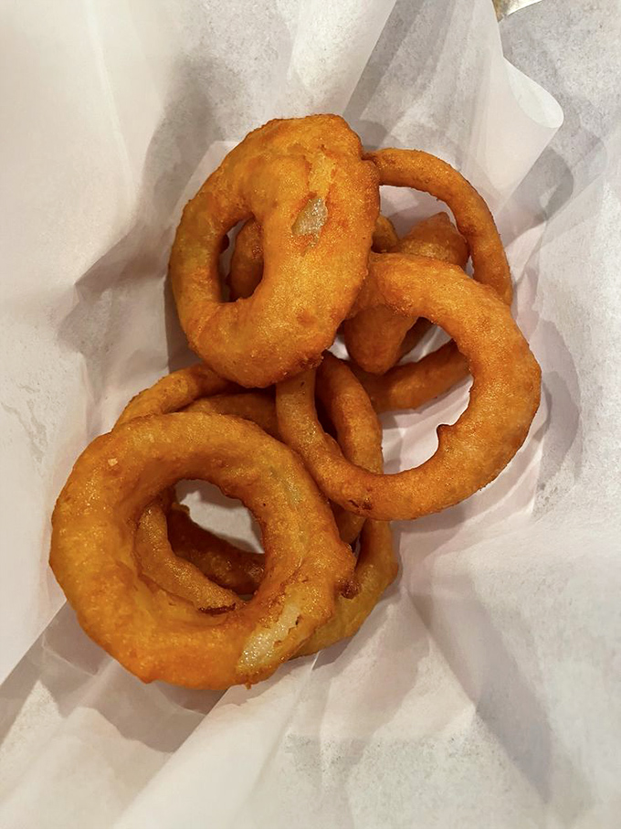 Beer-battered onion rings with that perfect pull—where the onion stays put until you want it to surrender. A textbook example of fried excellence.