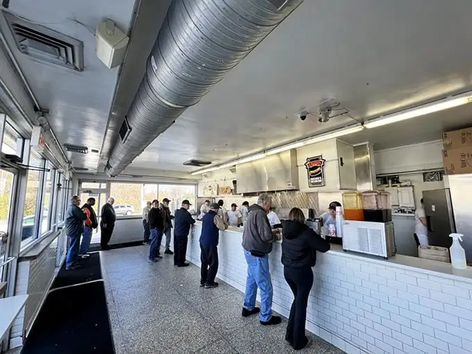 The assembly line of flavor operates with military precision. No wasted movements, no unnecessary flourishes—just hot dog perfection.