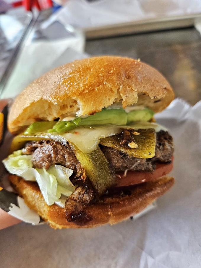 The Pancho Villa Burger doesn't just cross borders—it erases them. Green chiles and melted cheese create a diplomatic alliance your mouth will celebrate.