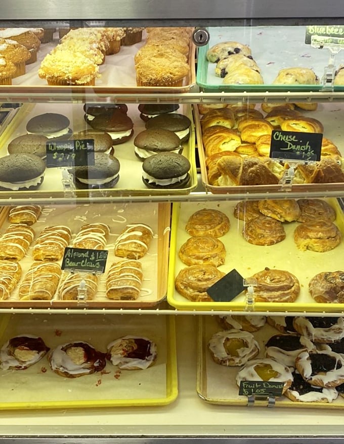 The display case at Sanitary Bakery – where willpower goes to die and "I'll just have one" becomes the day's most unconvincing lie.