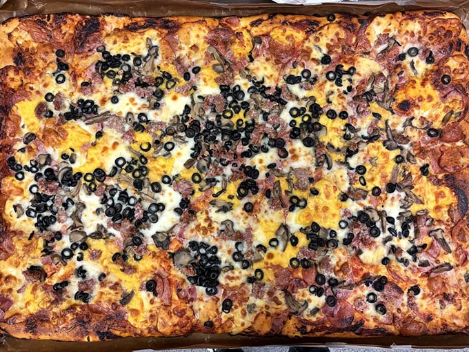 Square pizza that defies geometry by somehow tasting more satisfying than its round cousins. Those black olives aren't just toppings—they're exclamation points.