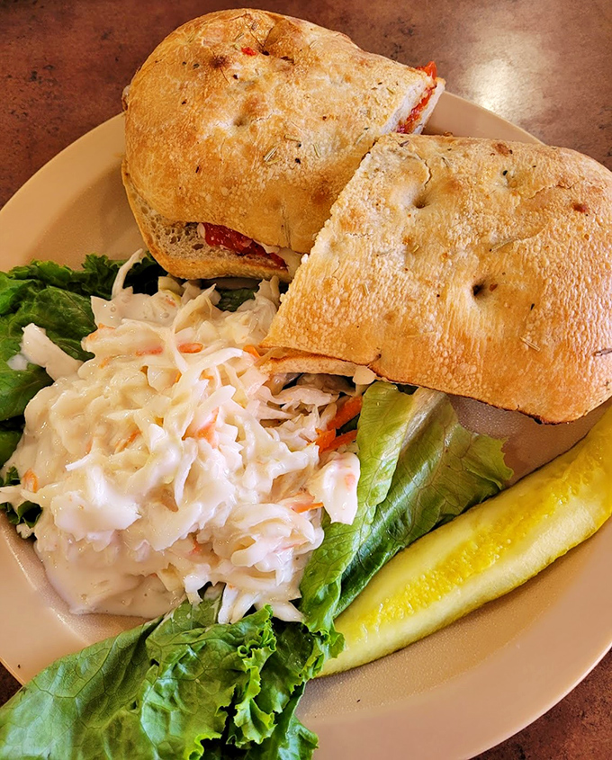 A sandwich that requires both hands and several napkins—the universal signal for "worth every messy bite." That coleslaw side act isn't just phoning it in either.