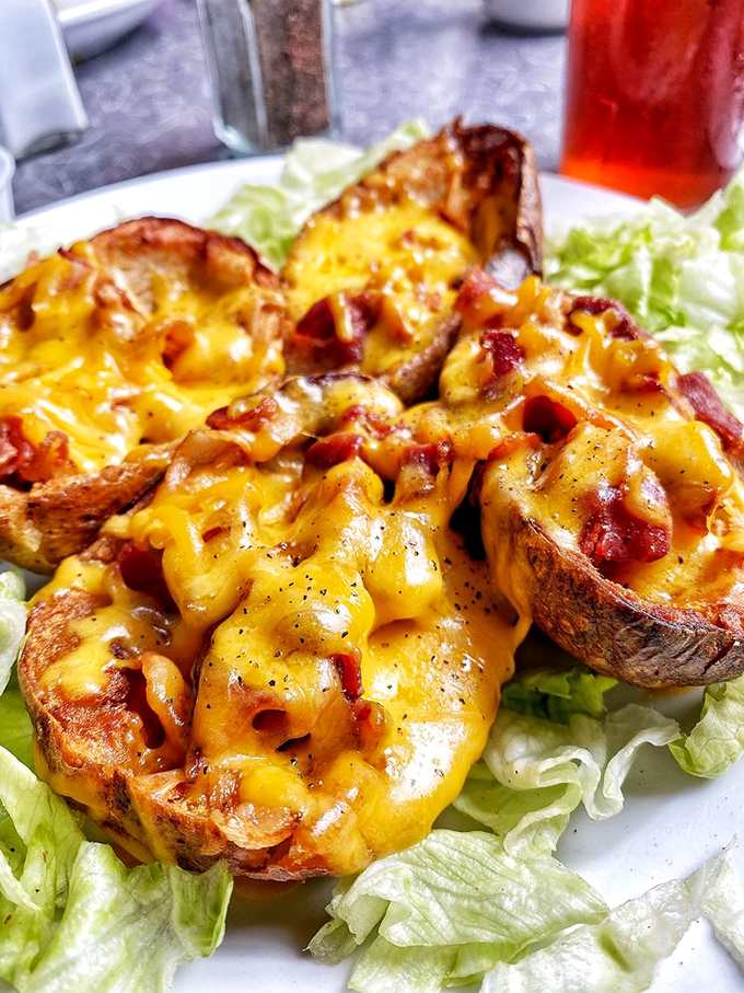 Potato skins—where a humble spud transforms into a cheese-covered vessel of joy. The ultimate proof that simple ingredients can create magic.