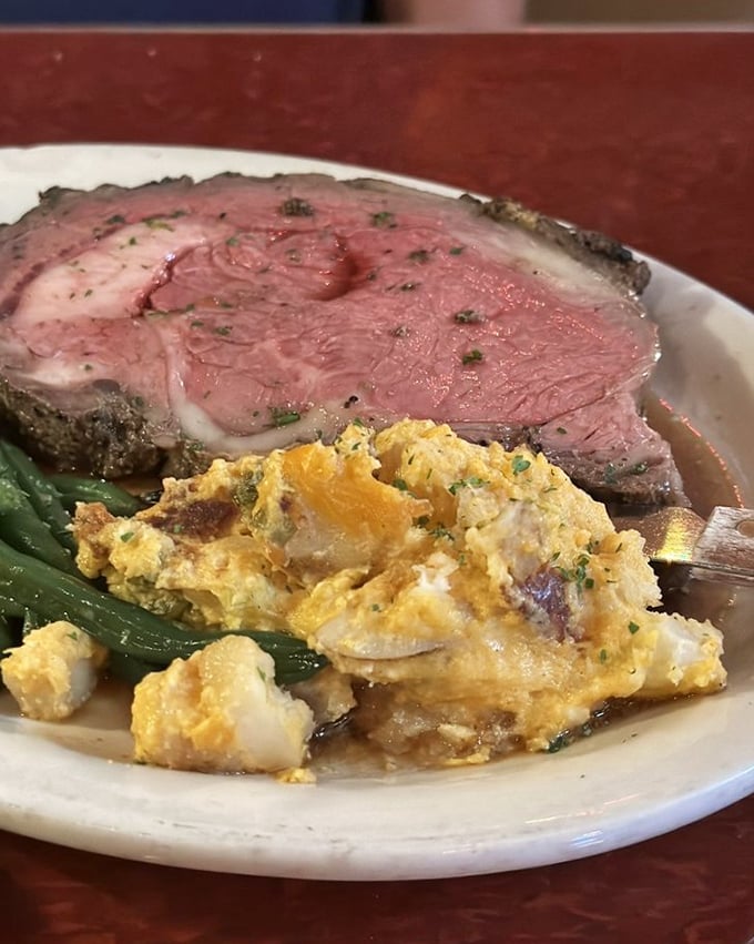 Prime rib so perfectly pink it could make a vegetarian question their life choices. That side of potato casserole isn't playing second fiddle—it's a co-star.