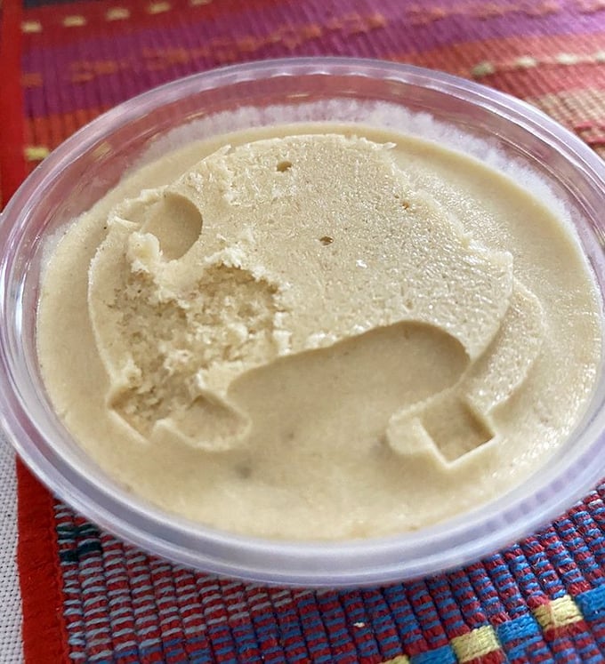 The creamy vanilla in this container isn't just dessert—it's a meditation on simplicity and the beauty of doing one thing exceptionally well.