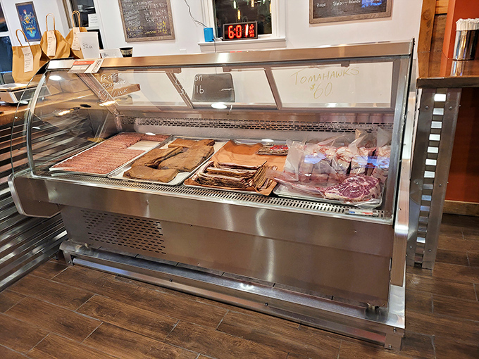 Behind this glass lies the promised land – meats awaiting their transformation from merely excellent to transcendent through the magic of smoke.